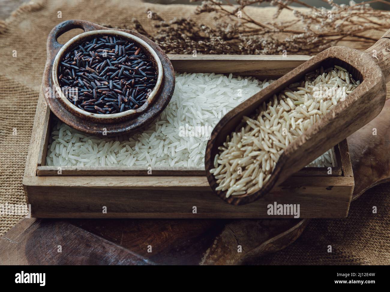 Various types of rice : Brown rice, Jasmine rice, Riceberry on old ...