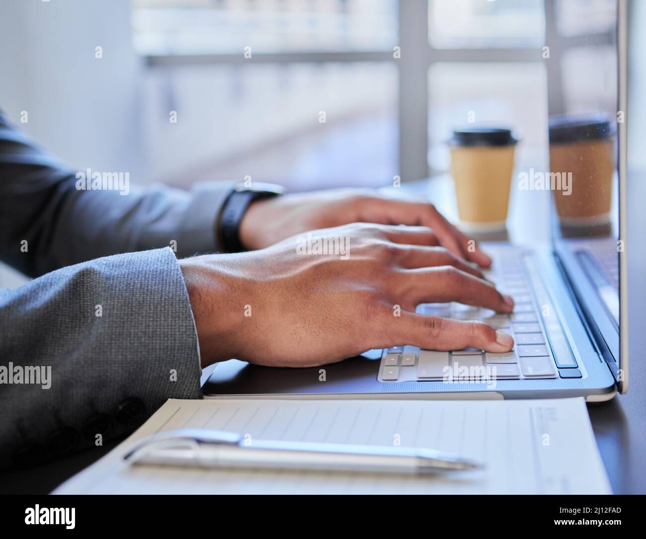Working hard to achieve my goals. Shot of a businessman using his ...