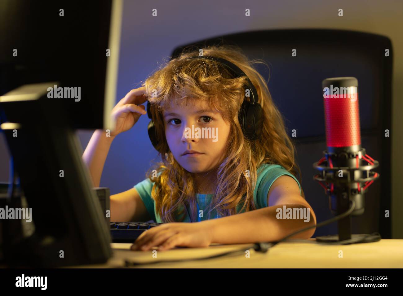 Child learning in virtual online school class. Kid working on laptop ...