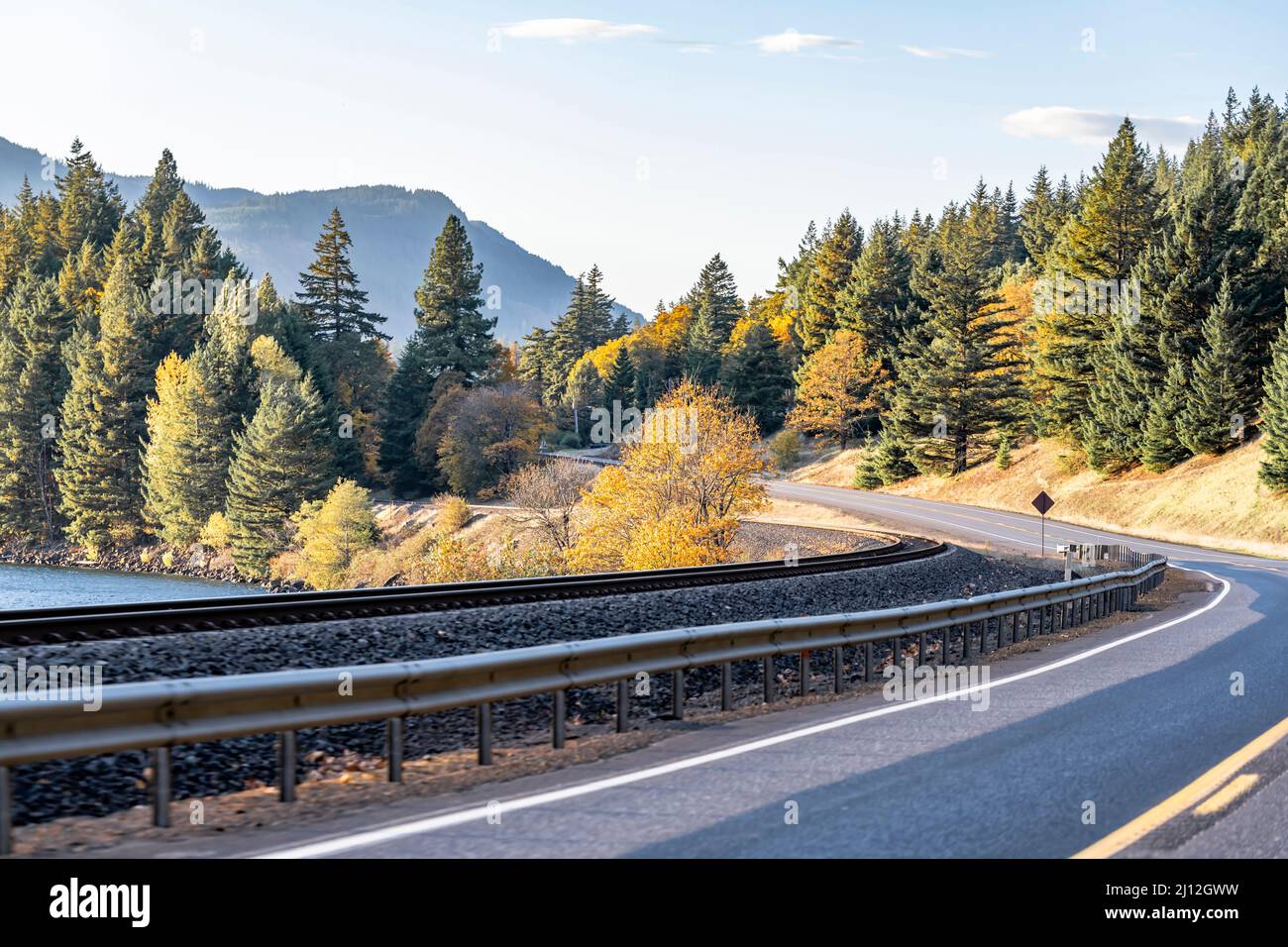 Scenic autumn landscape with a disappearing around the corner winding ...
