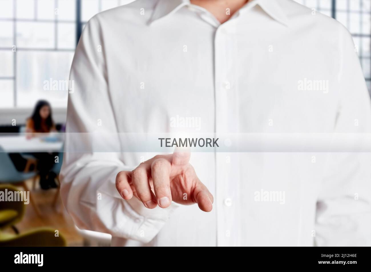Businessman hand presses teamwork button on a virtual touch screen ...