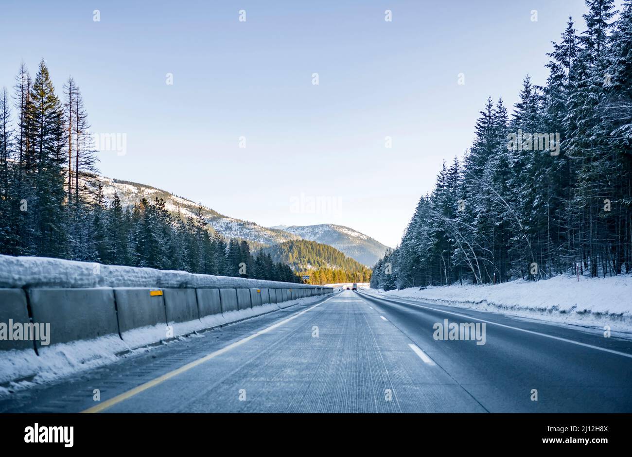Scenic winter dangerous icy slippery winding highway road with piles of ...