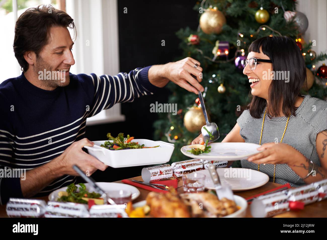Proud of his Christmas lunch. Shot of a happy young couple eating ...