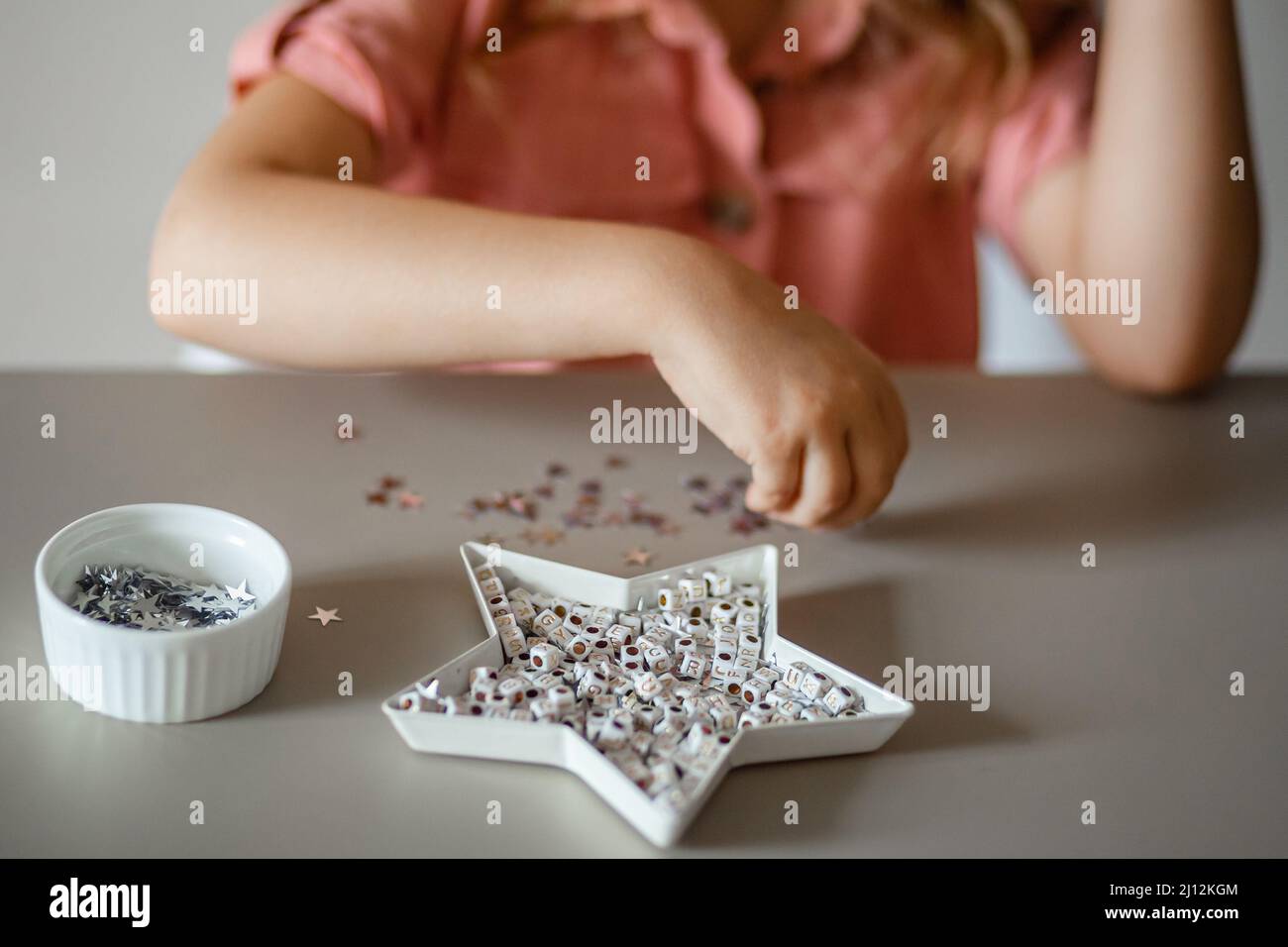 cute little blonde girl is engaged in creativity doing crafts Stock ...