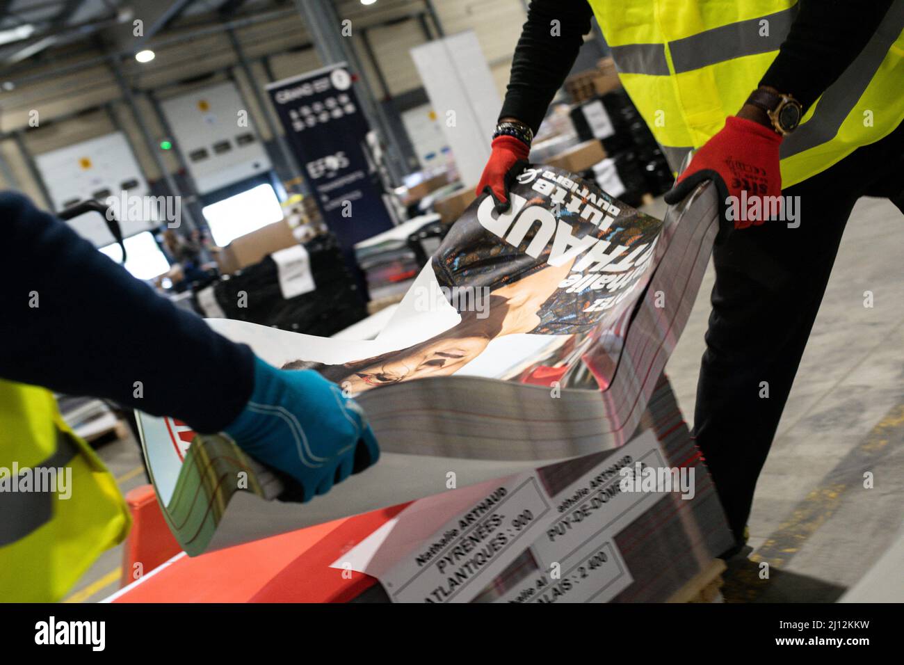 A man pulls a cart with campaign posters of candidate Nathaie Arthaud ...
