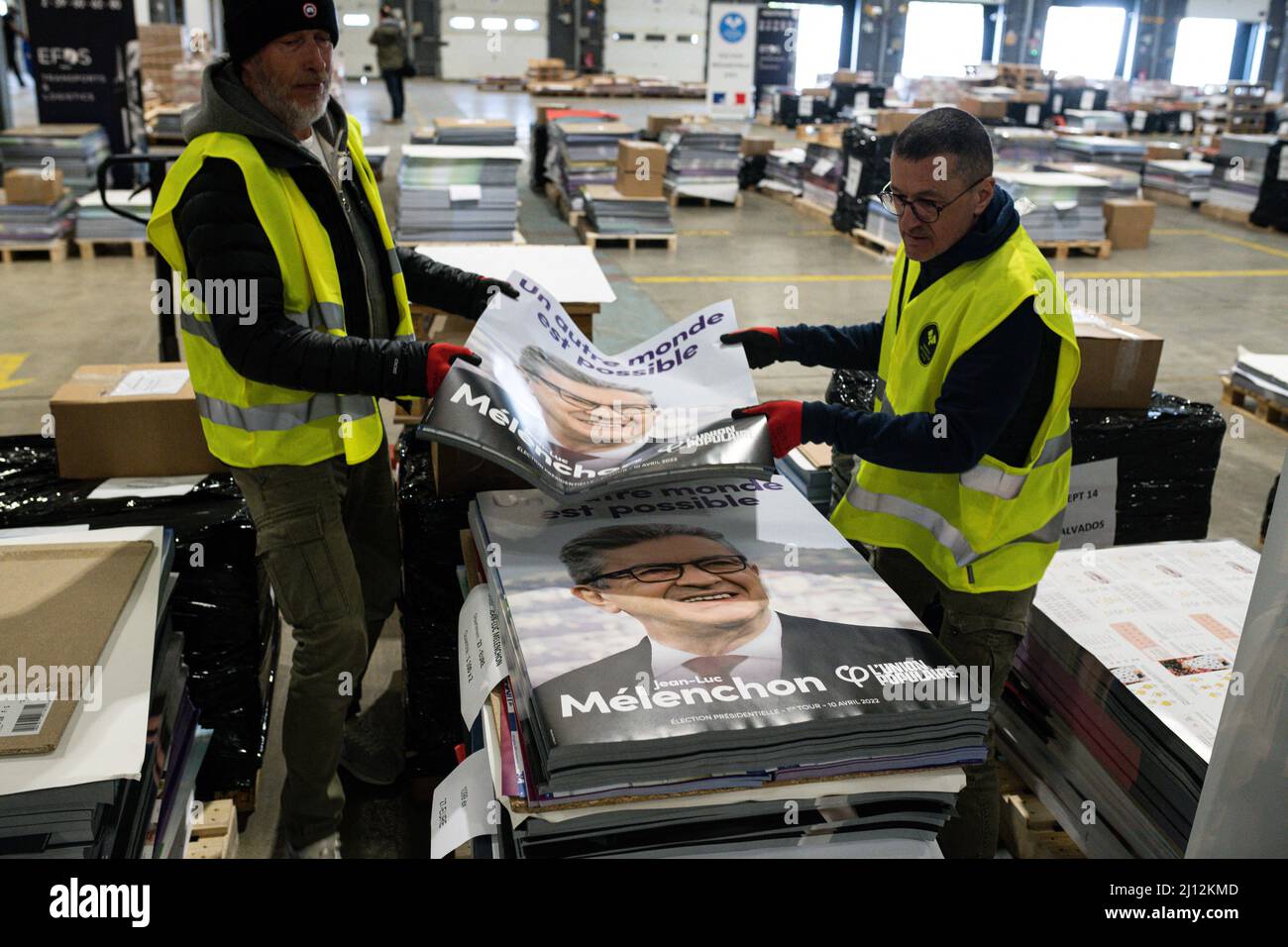 Two men carry campaign posters of the candidate Jean Luc Melechon in ...