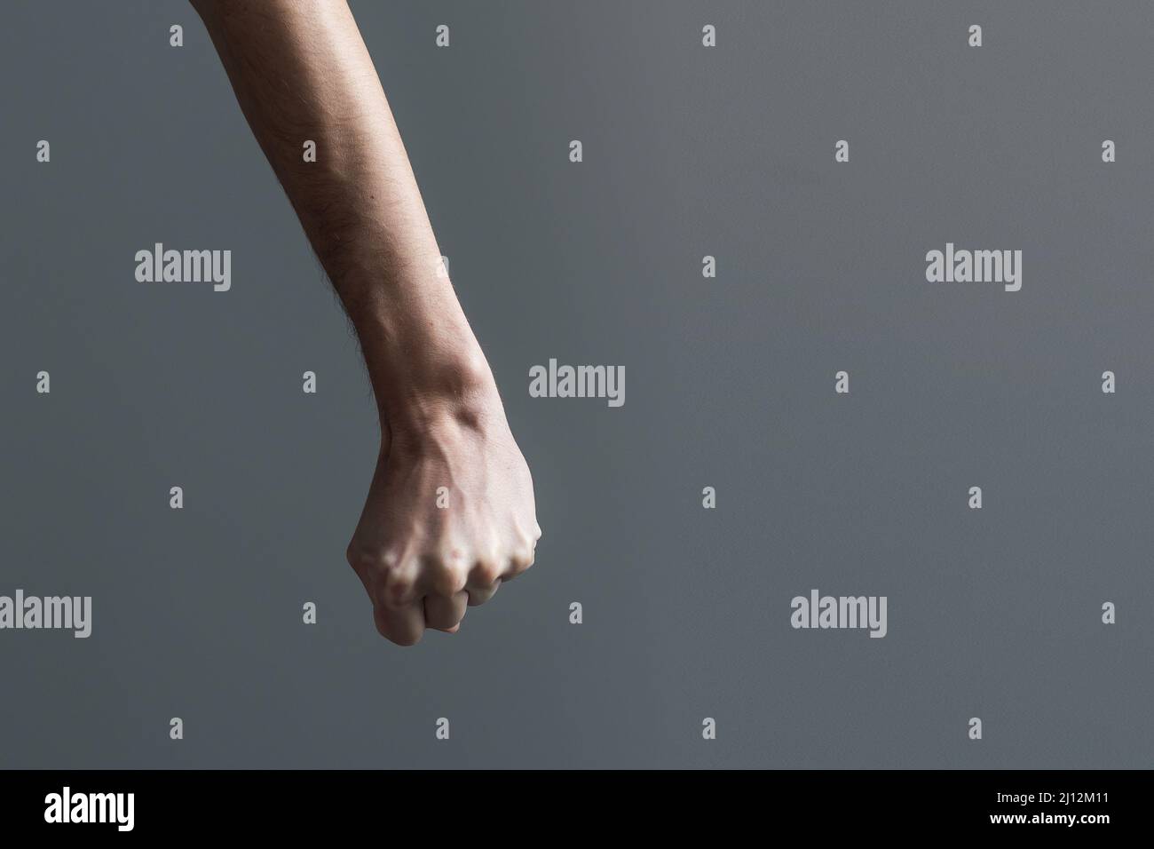 view of the fist of an aggressive man committing domestic violence ...
