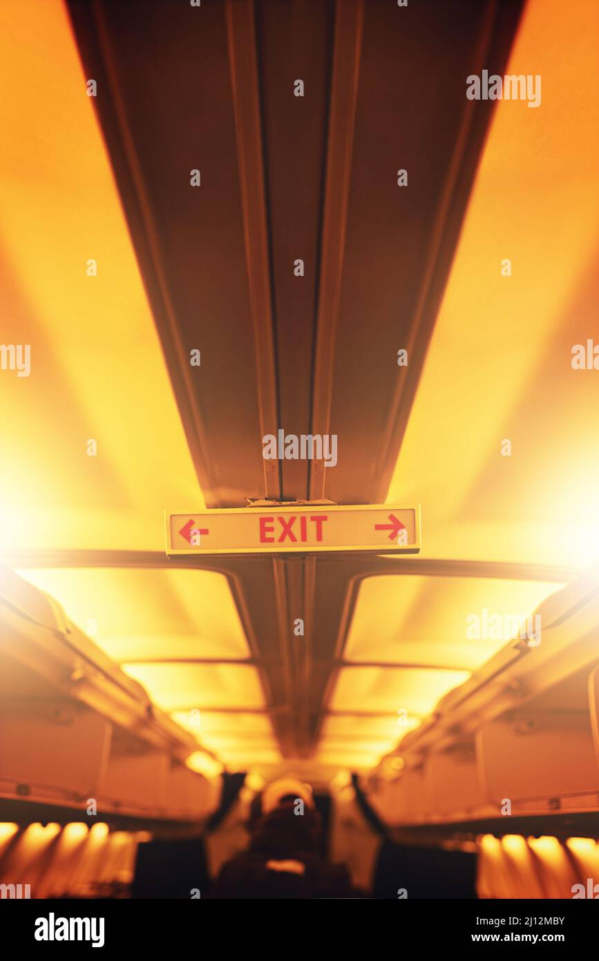 Attention passengers Please take note of the emergency exits. Shot of ...