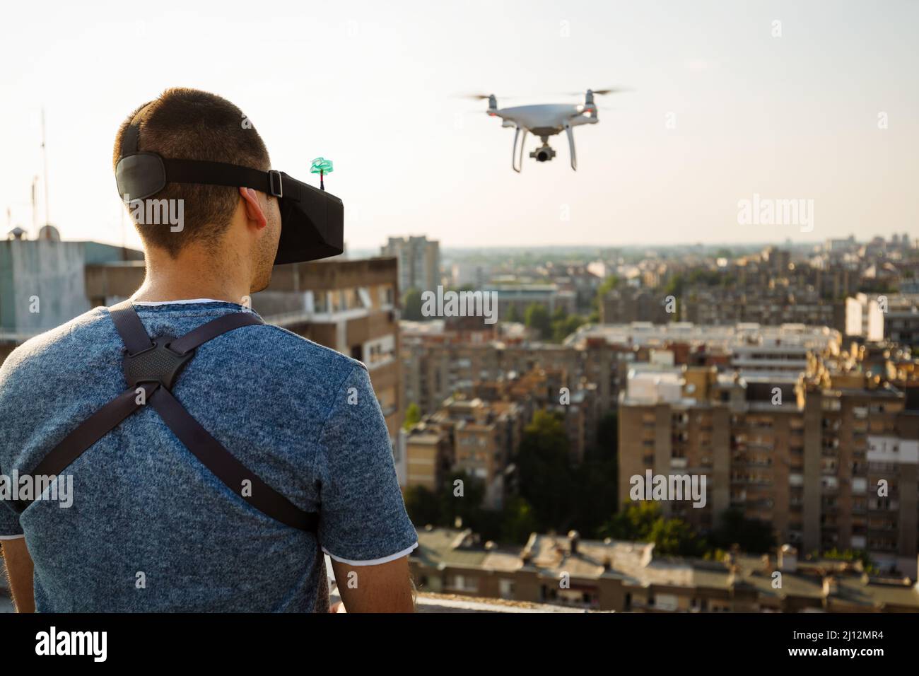 Young technician flying UAV drone with remote control on rooftop Stock ...