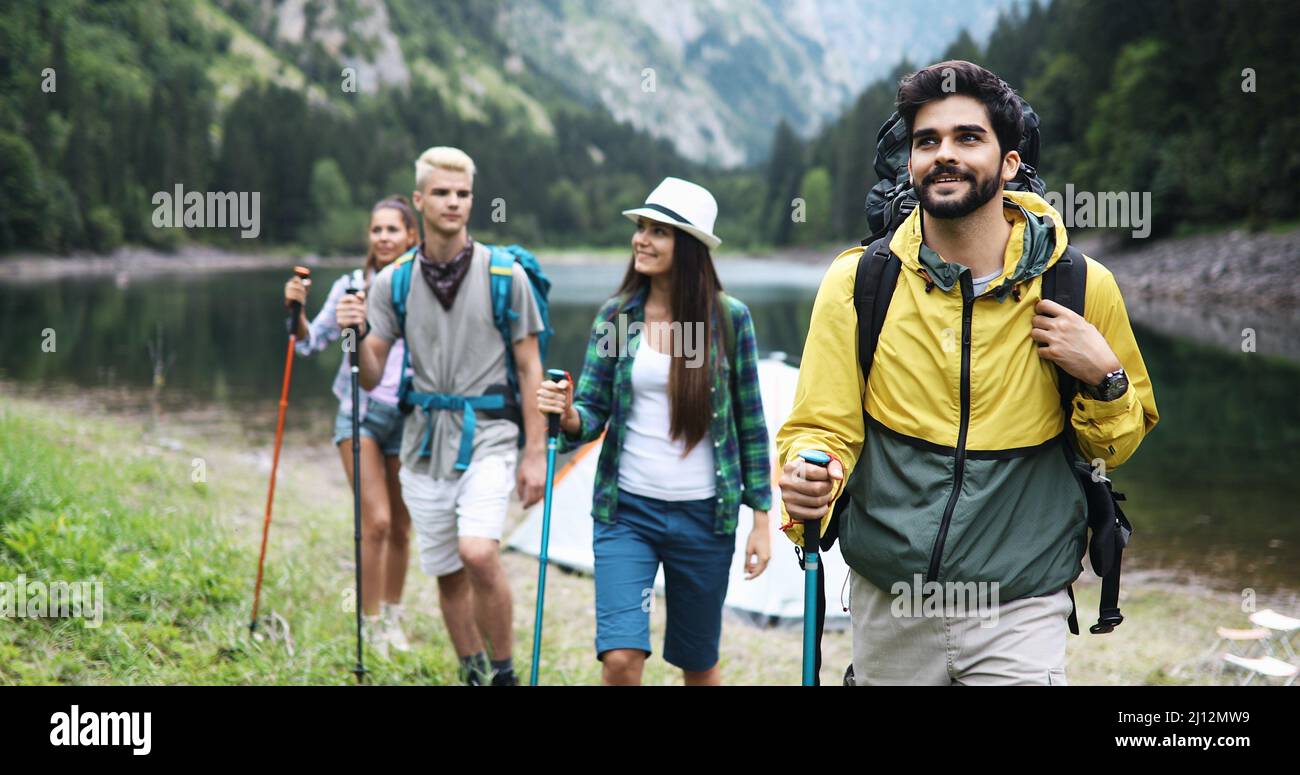 Group of friends hiking together outdoors exploring the wilderness and ...