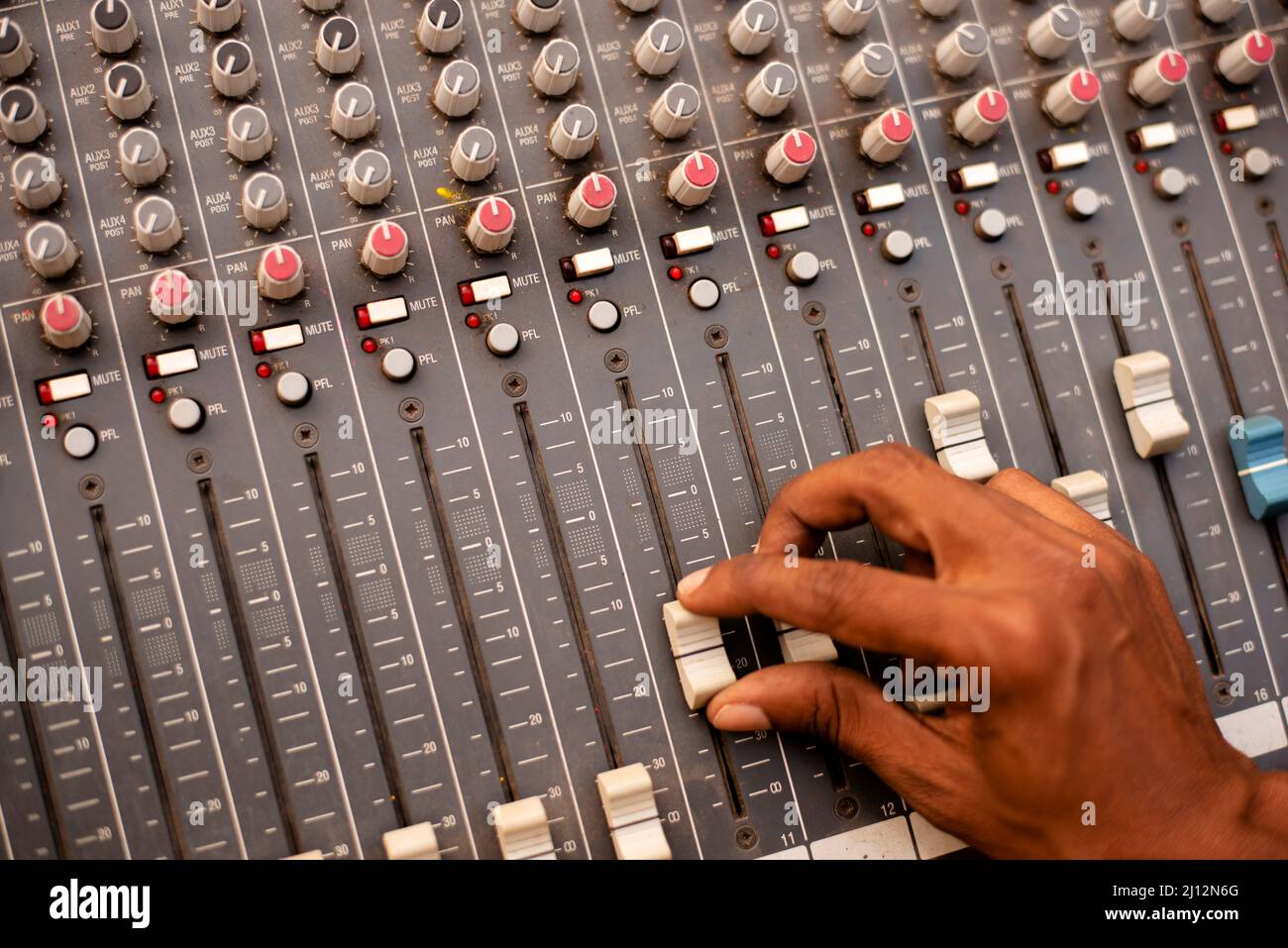 Adjusting audio in a sound mixer control panel Stock Photo - Alamy