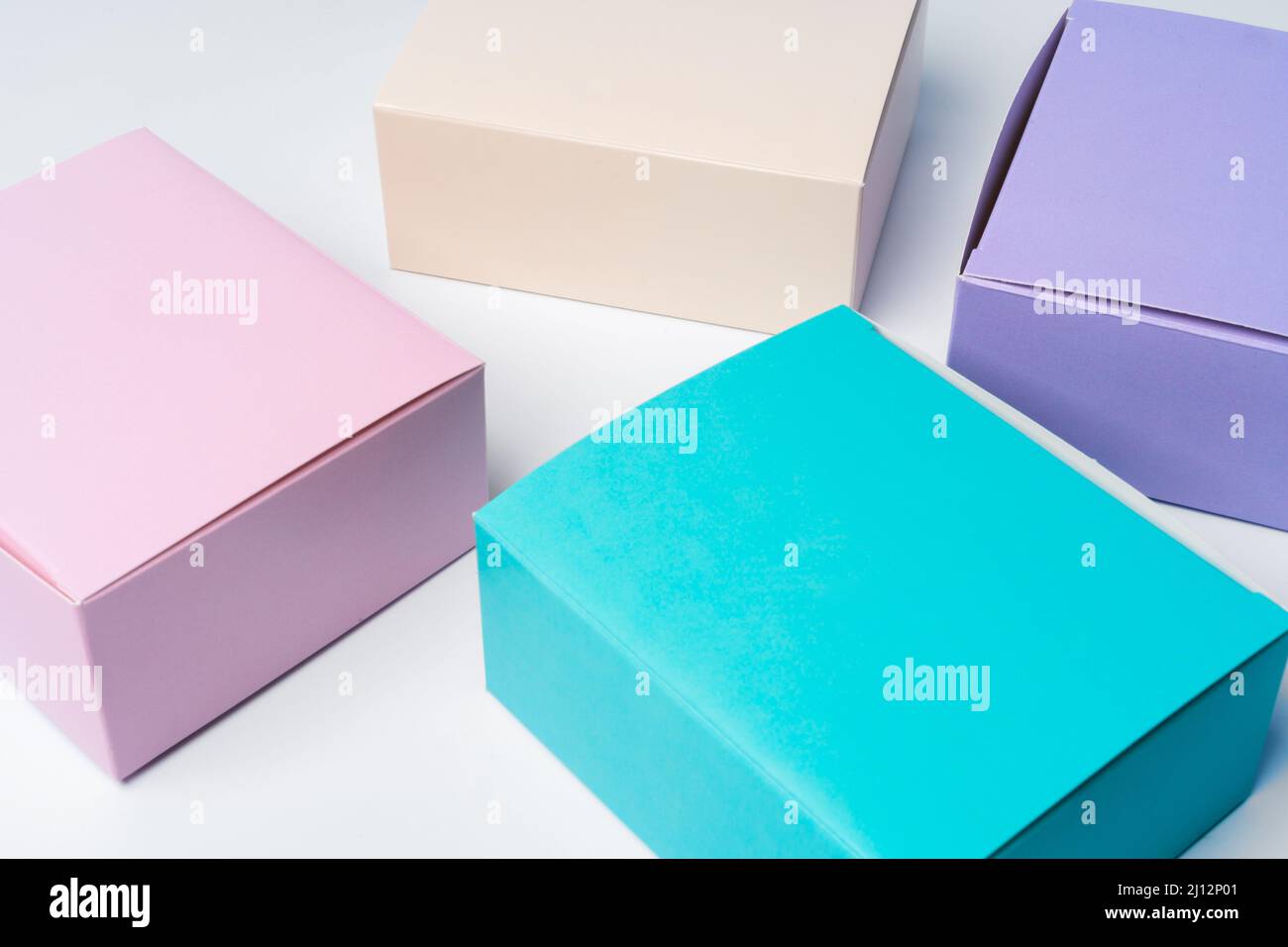 Pile of colorful cardboard boxes on white background Stock Photo - Alamy