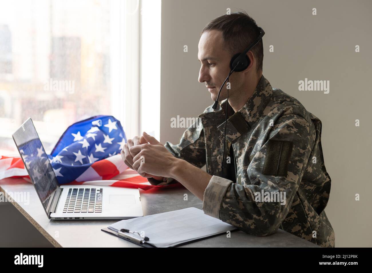 Happy army soldier having video call over laptop Stock Photo - Alamy