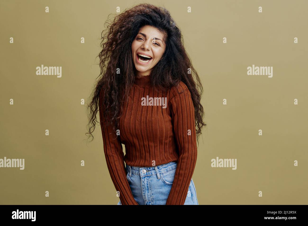 Cheerful pretty curly Caucasian female stay isolated, looking at the ...