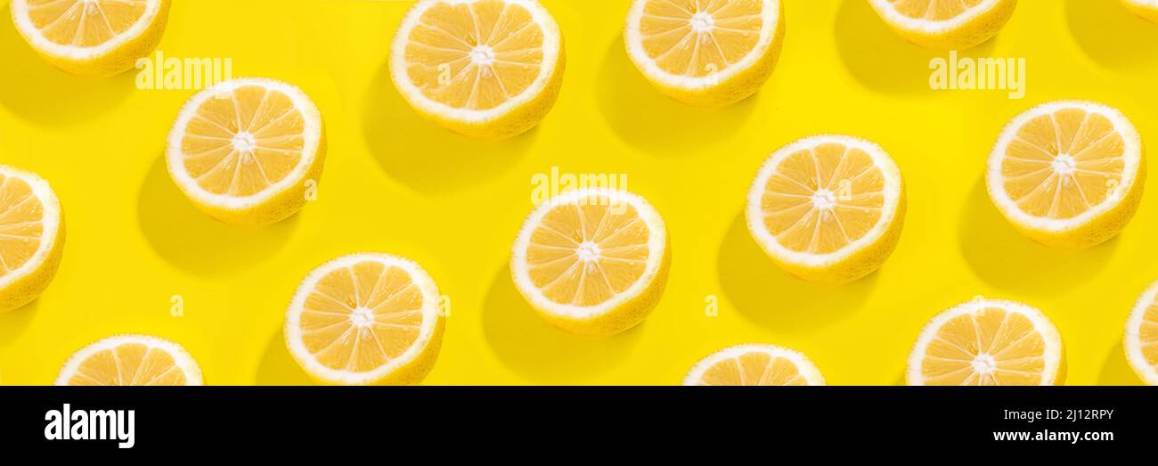 Slices of fresh yellow lemon pattern on bright yellow background ...