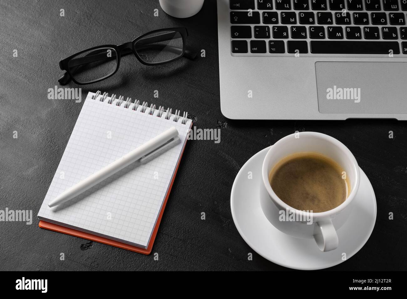 Notepad is on top of office desk table with laptop and supplies Stock ...