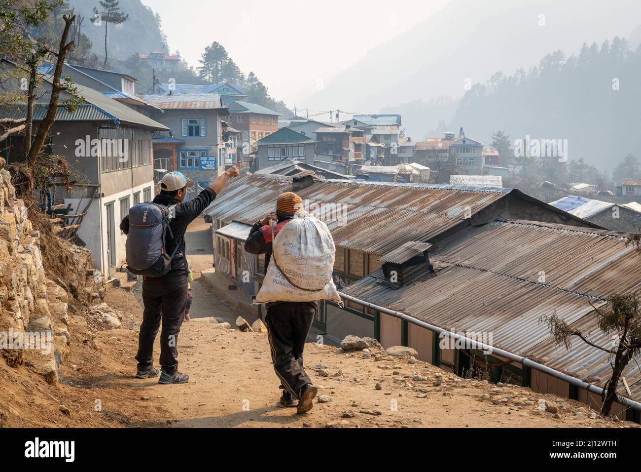 Phakding, Nepal - March 10, 2022: A porter on the trail to Everest Base ...
