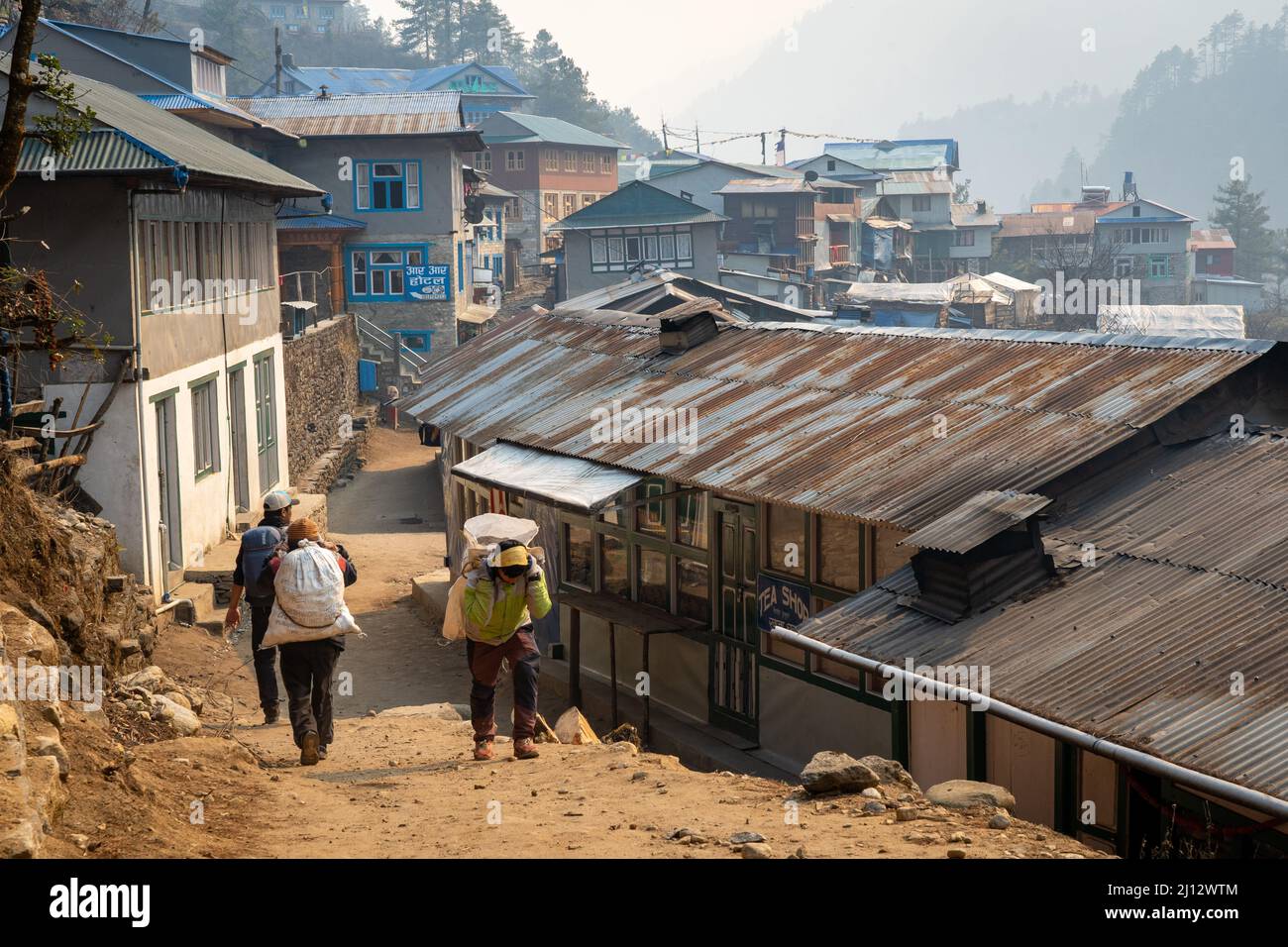 Phakding, Nepal - March 10, 2022: A porter on the trail to Everest Base ...