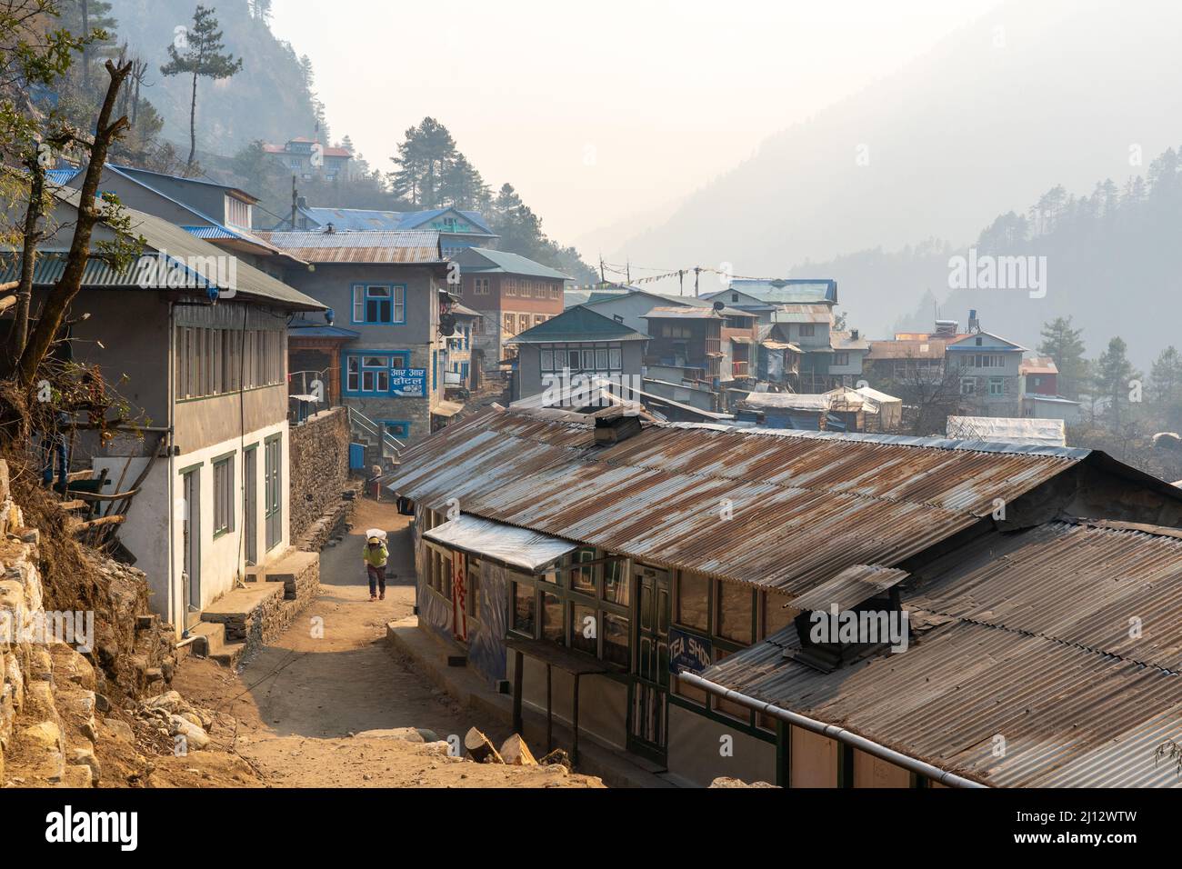 Phakding, Nepal - March 10, 2022: A porter on the trail to Everest Base ...