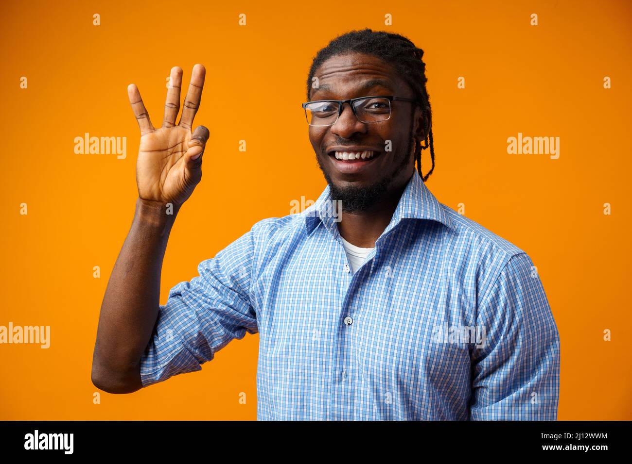 Smiling black man giving ok sign isolated on yellow background Stock ...