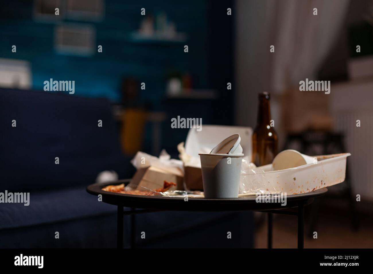 Empty messy living room with trash cans and leftovers rubbish on table ...
