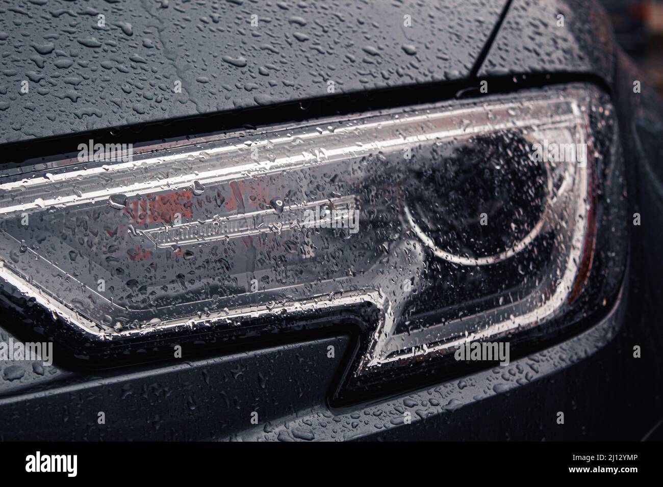 Front left headlight on a blue car Stock Photo - Alamy