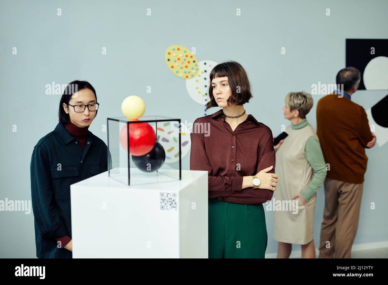 Group of modern senior and young people visiting exhibition in art ...