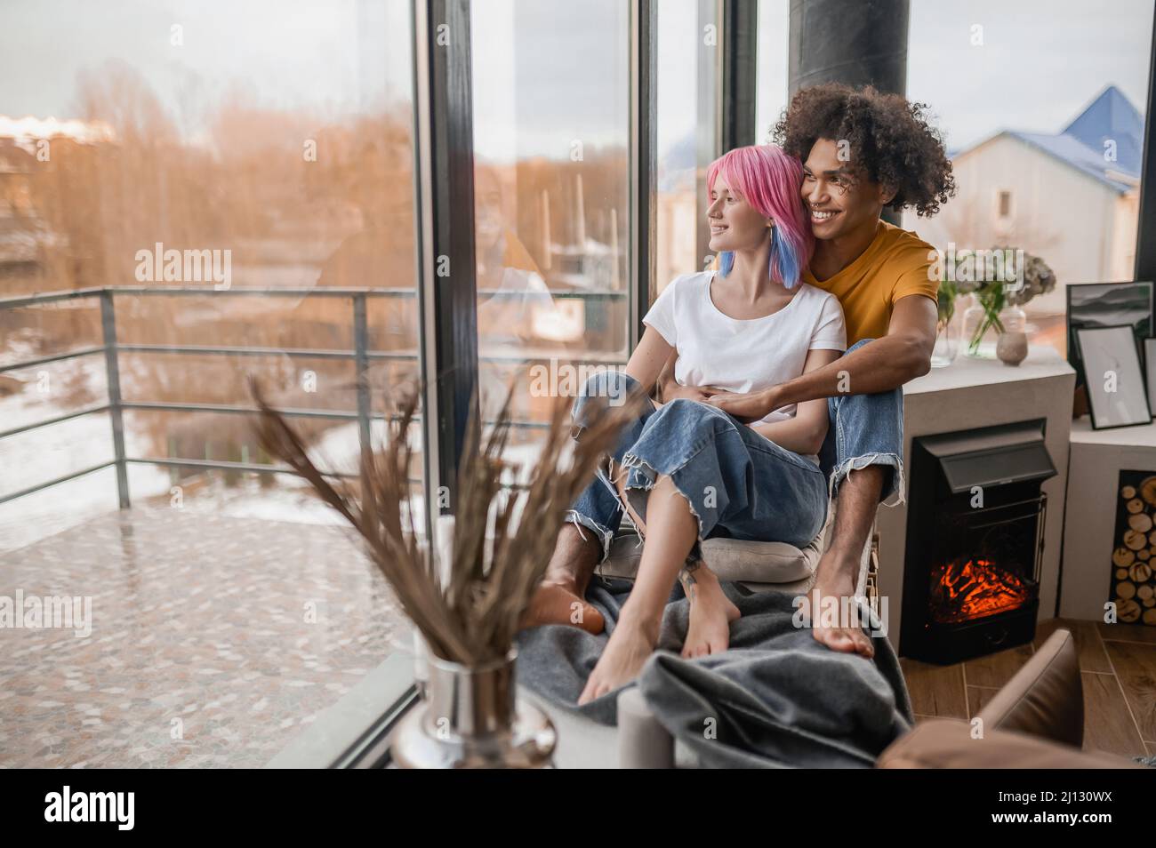 Young man and woman sitting in the chair hugging each other Stock Photo ...