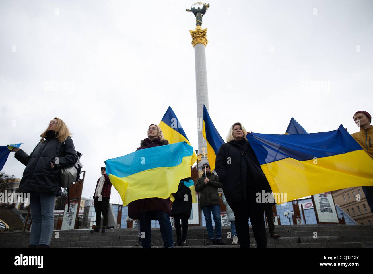 Ukrainians hold Ukrainian flags as Musicians of the Kyiv-Classic ...