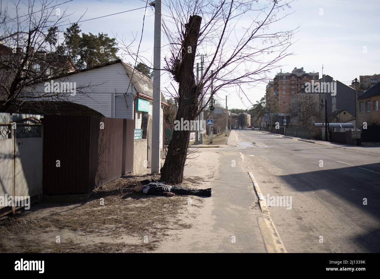 A corpse lays on the ground in a street of Central Irpin on March 11 ...