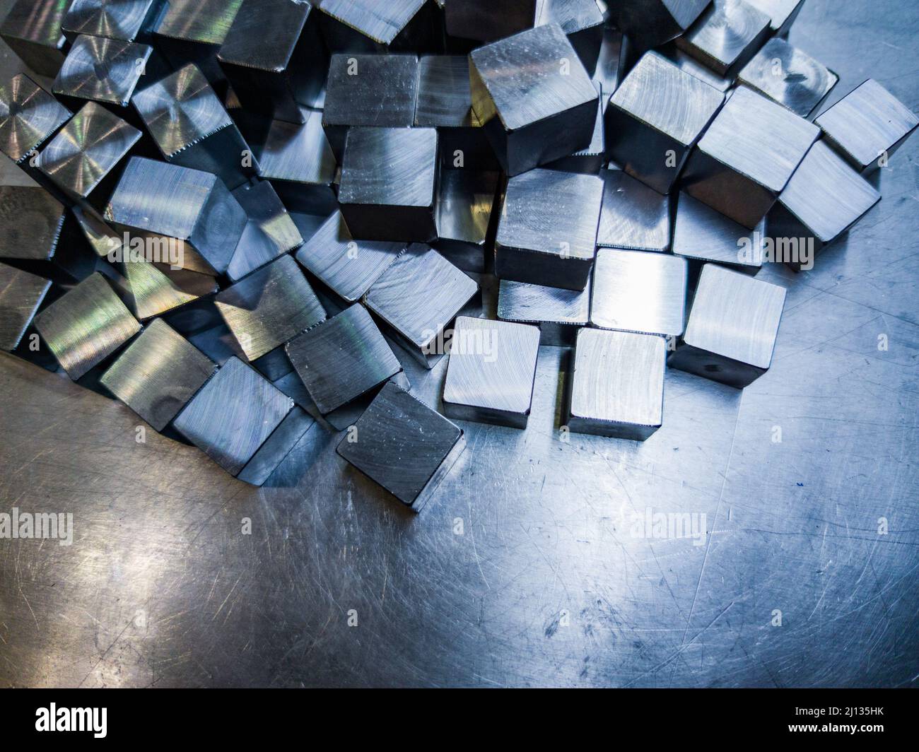 pile of small machined shiny steel cubes on metal surface Stock Photo ...