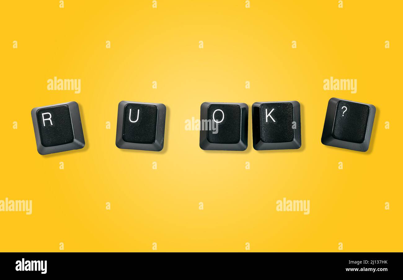 Computer keyboard keys spelling R U OK?, isolated on a yellow ...