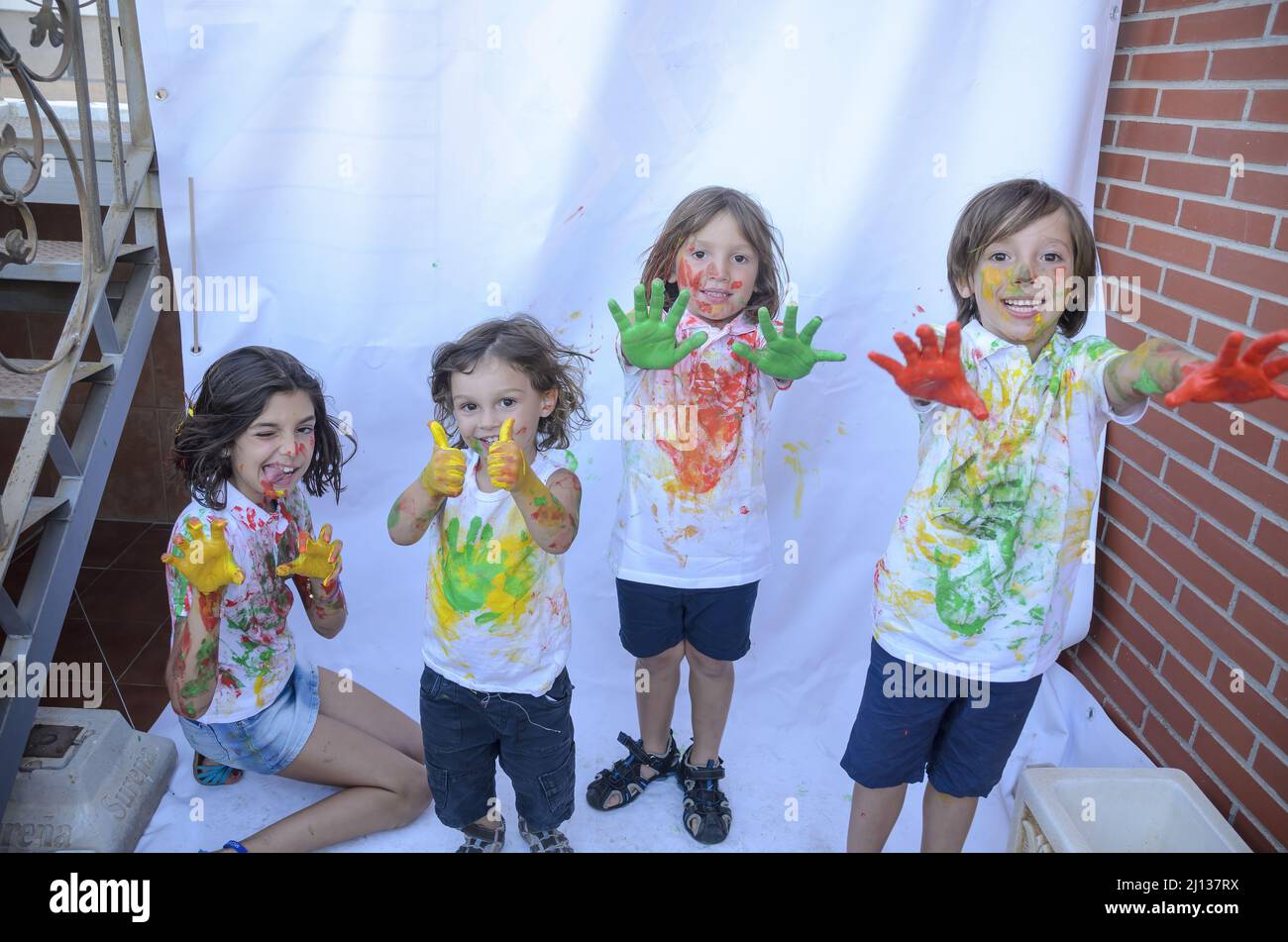 Kids playing with paint and getting stained, lot of fun Stock Photo - Alamy