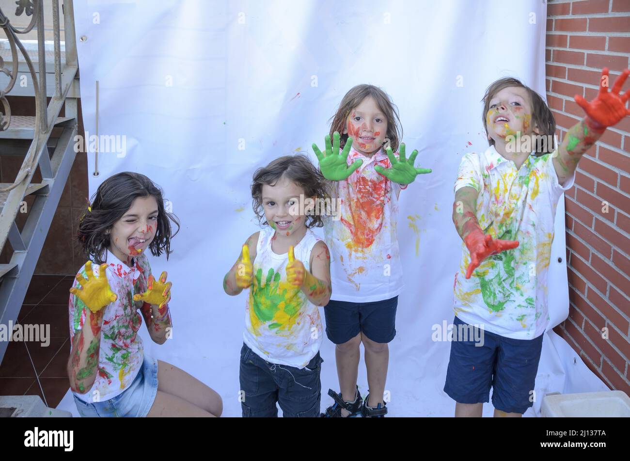Kids playing with paint and getting stained, lot of fun Stock Photo - Alamy