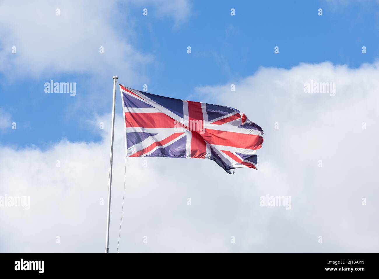 Union Jack flag of United Kingdom flyiing with ripped edges Stock Photo ...