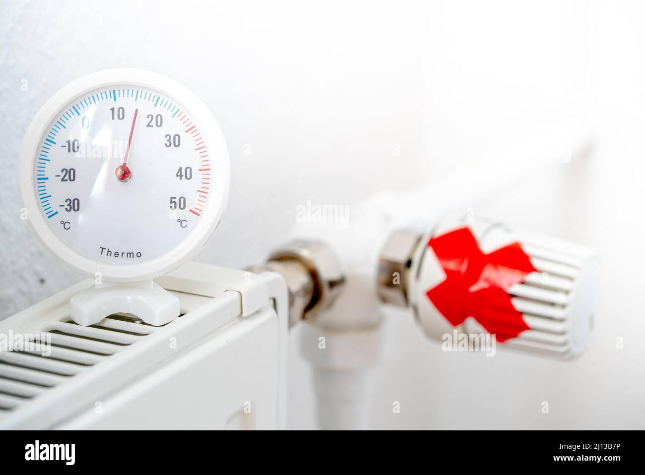 turn off home heating radiator and a thermometer showing 16 degrees ...