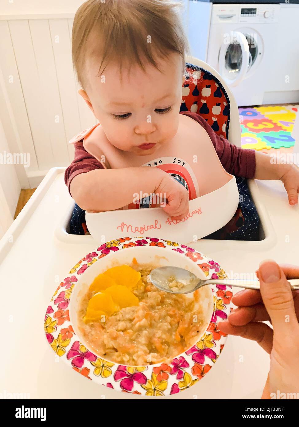 Baby boy eating oatmeal hi-res stock photography and images - Alamy