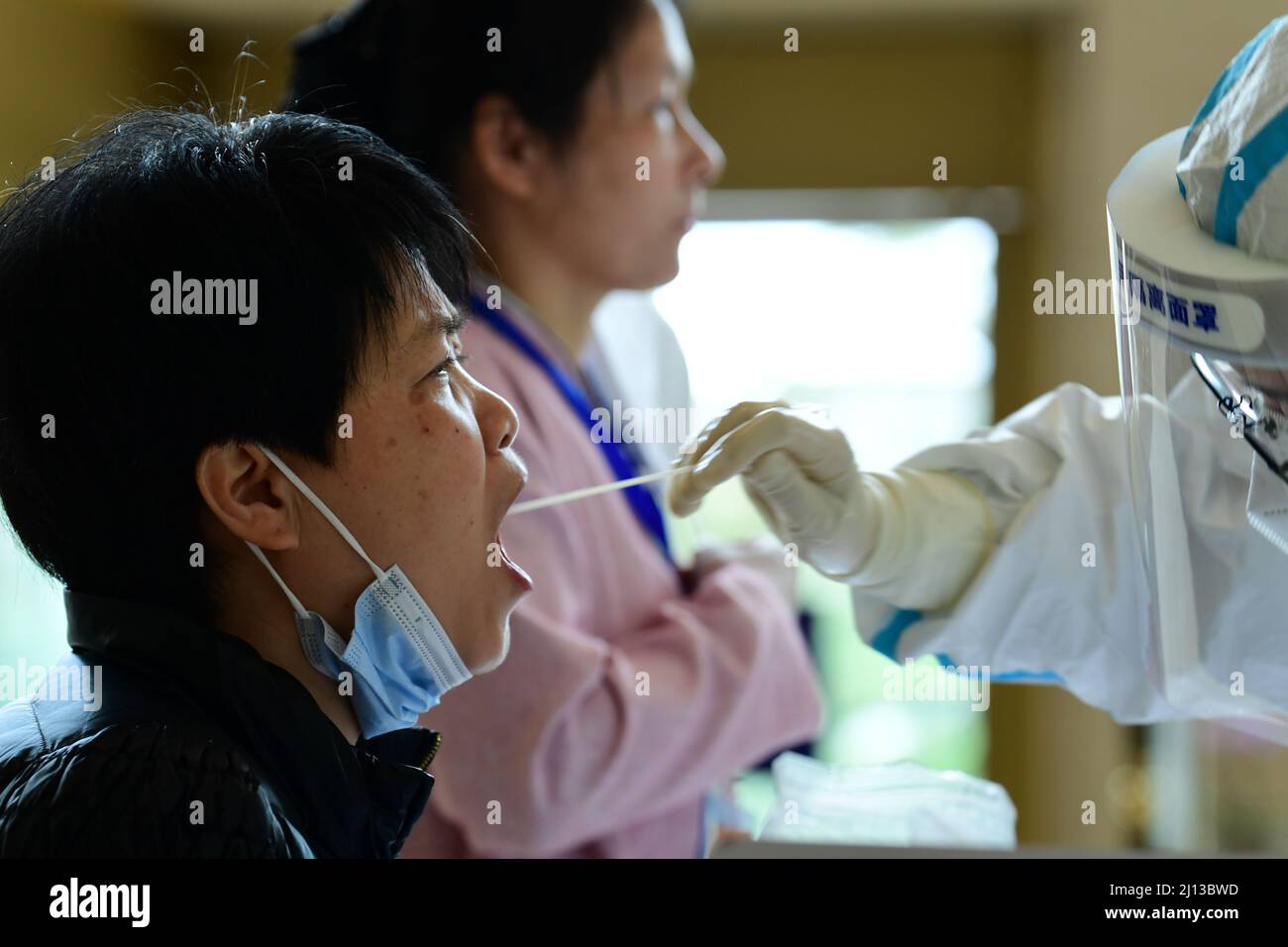 SUZHOU, CHINA - MARCH 22, 2022 - A citizen receives a nucleic acid test ...