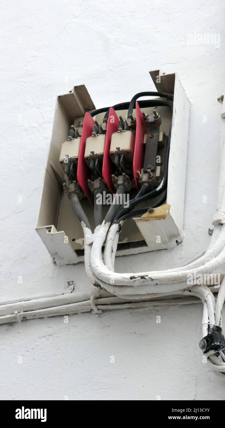 Wall mounted junction box without cover on Andalusian village wall ...