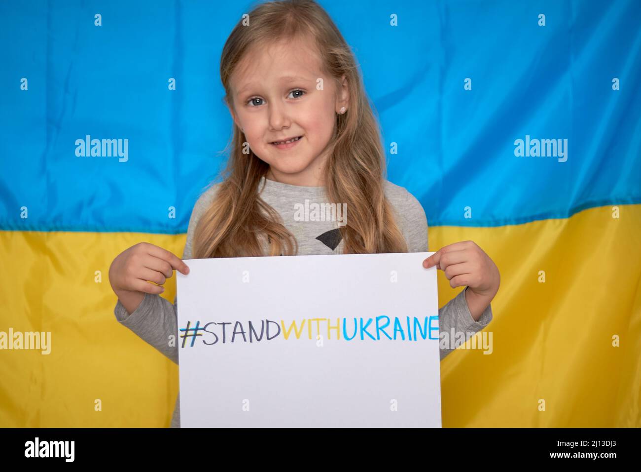 Girl hands holding paper banner with drawn yellow-blue staywithUkraine ...