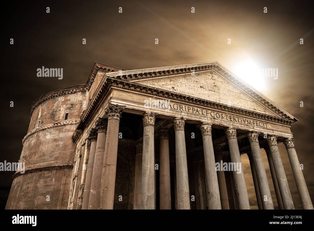 Pantheon of Rome against a dark dramatic sky with sunbeams, Italy ...