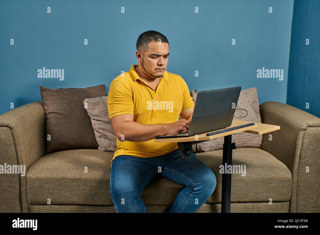 Hispanic Latino man working from home and getting ready on his Stock ...