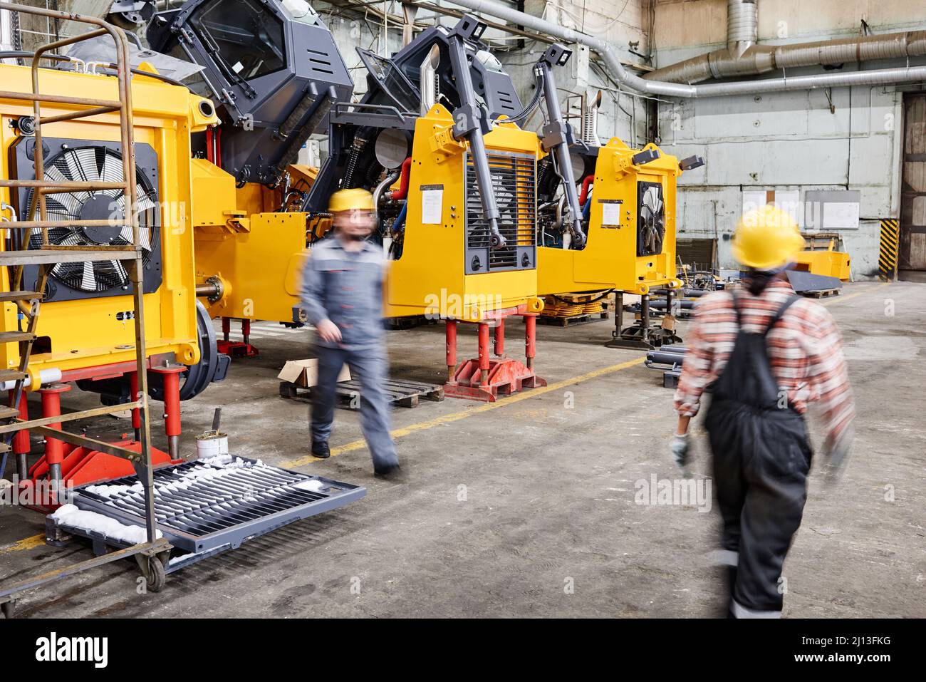 Blurred motion of two workers of industrial plant walking along ...