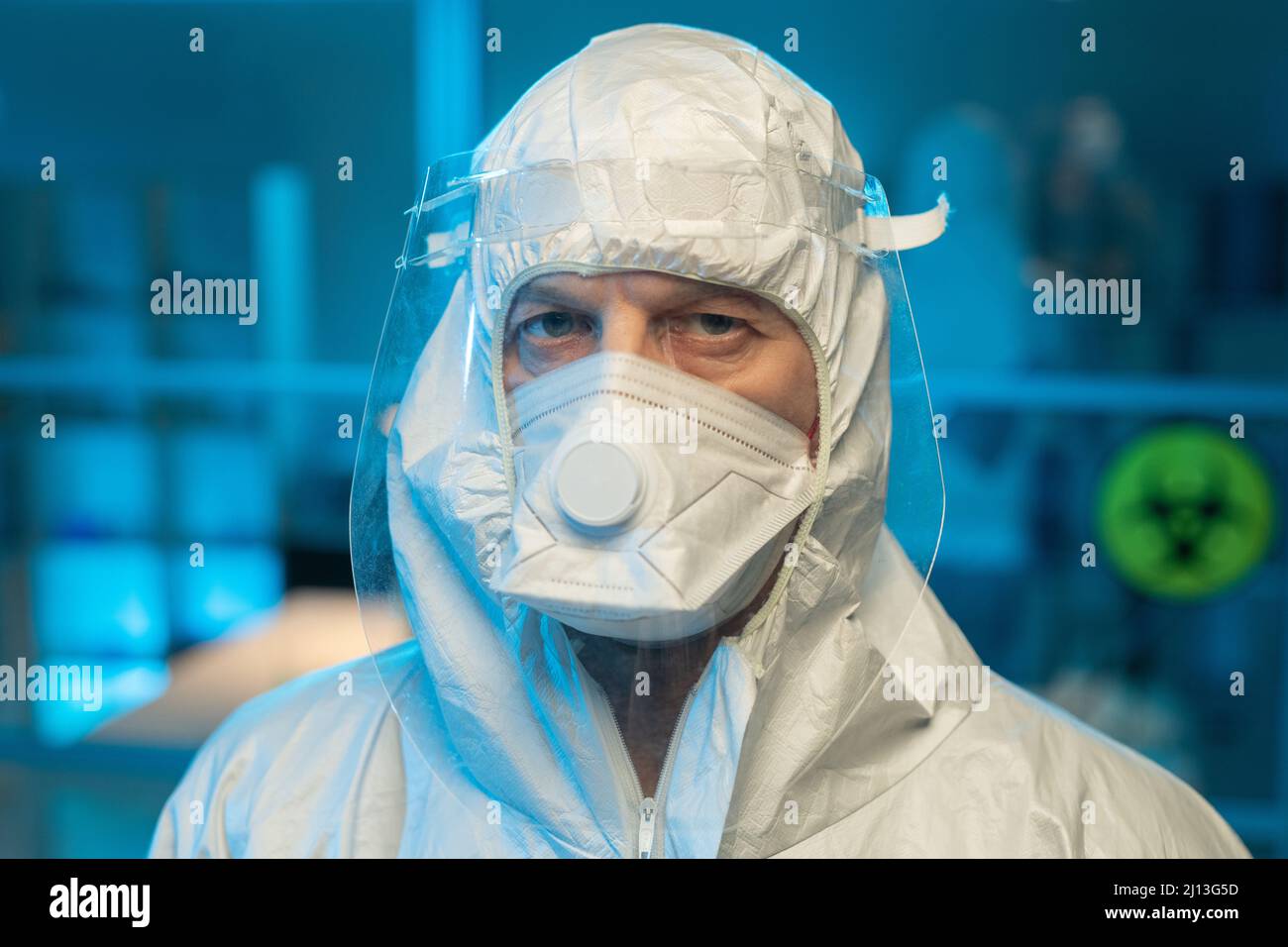 Face of male researcher in biohazard suit, respirator and protective ...
