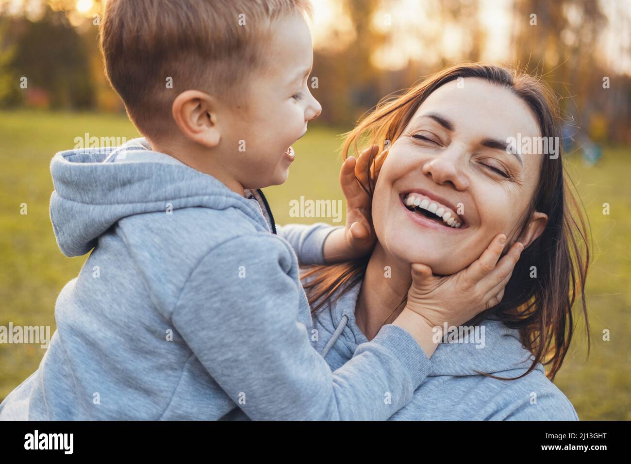 Mother and her child enjoying the early spring together in the park ...