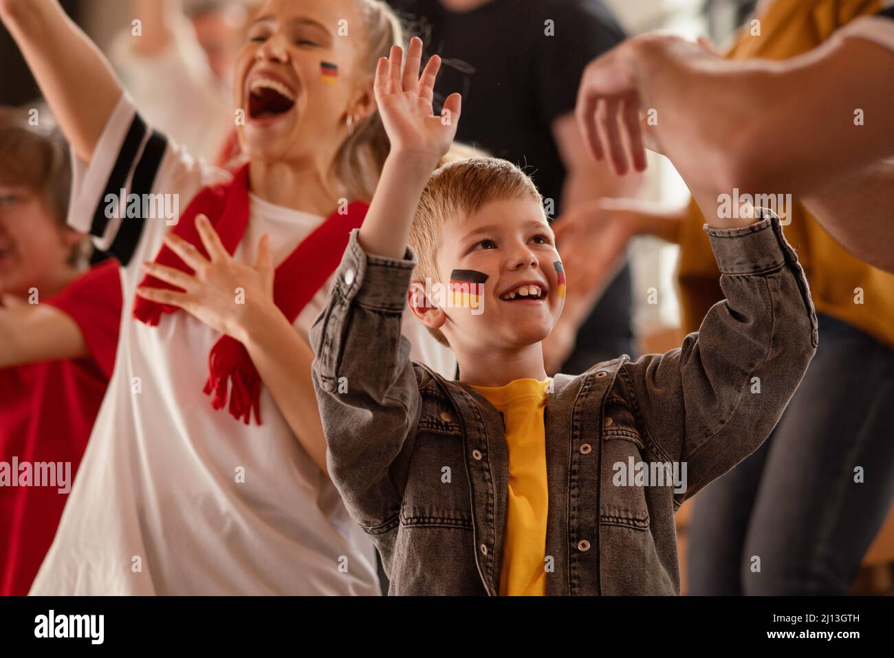 Young German football fans celebrating their team's victory at stadium ...