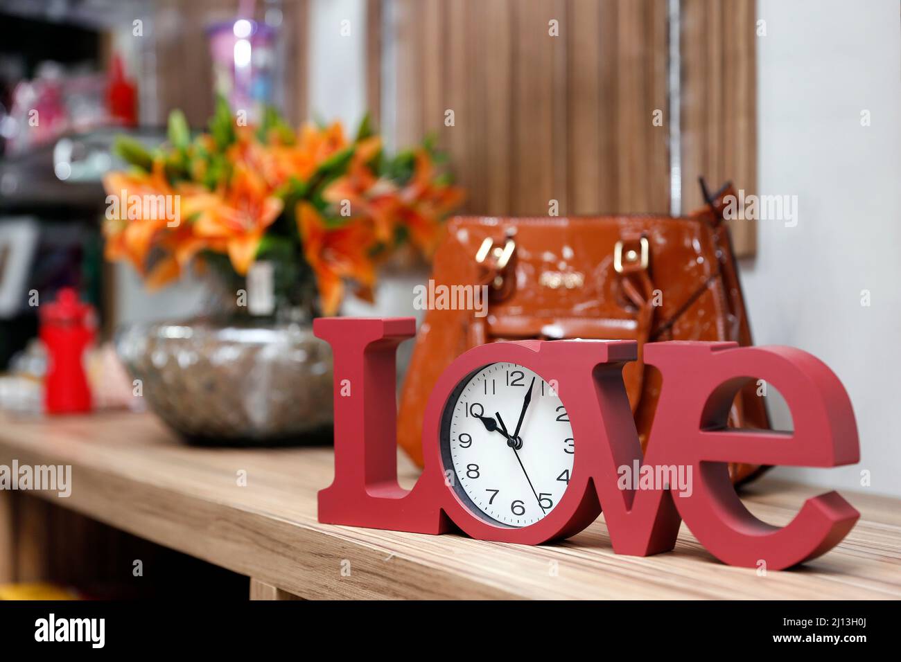 love wooden letters on clock in red color Stock Photo - Alamy