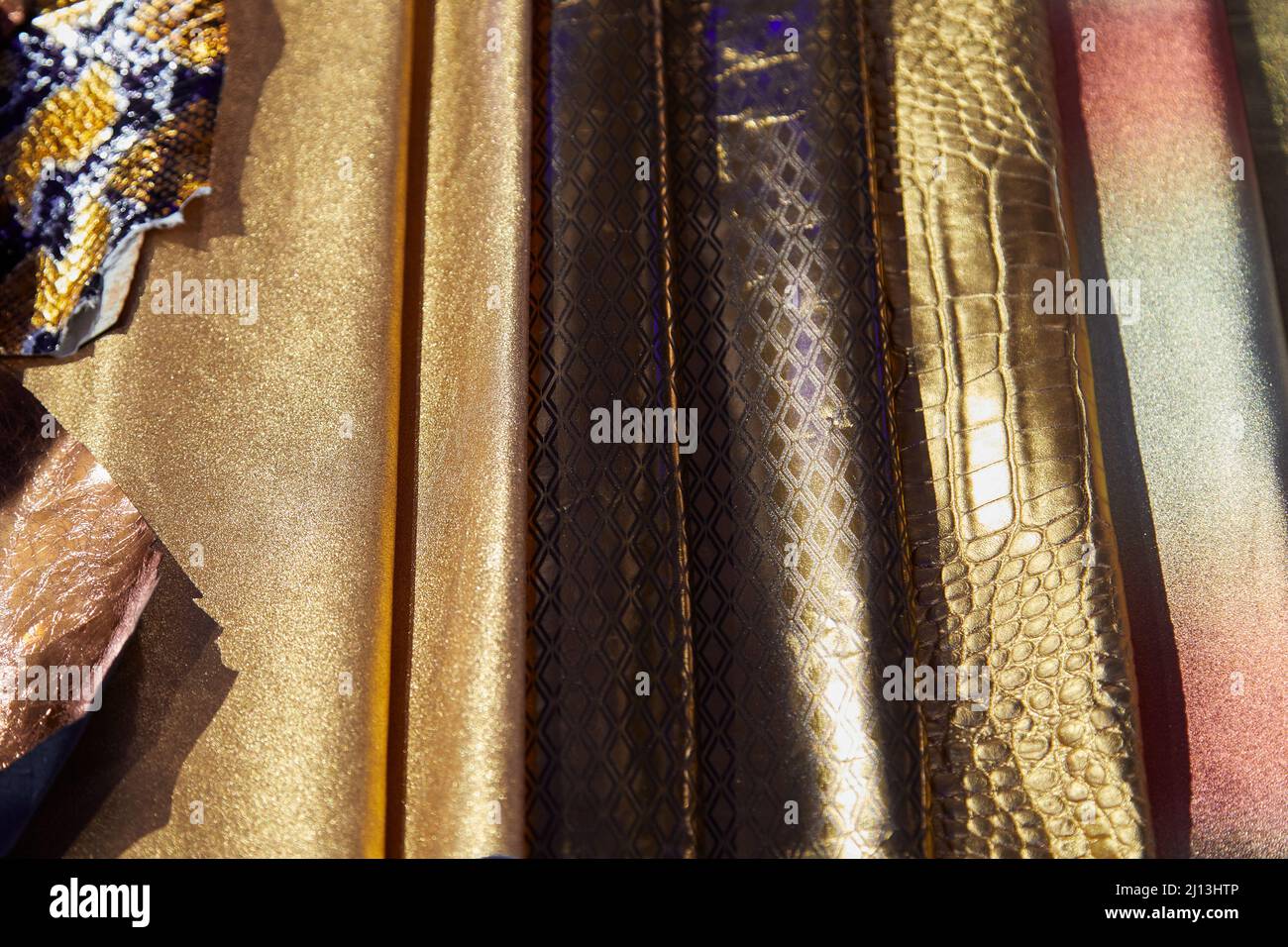 Golden and metallic leather samples texture background Stock Photo - Alamy