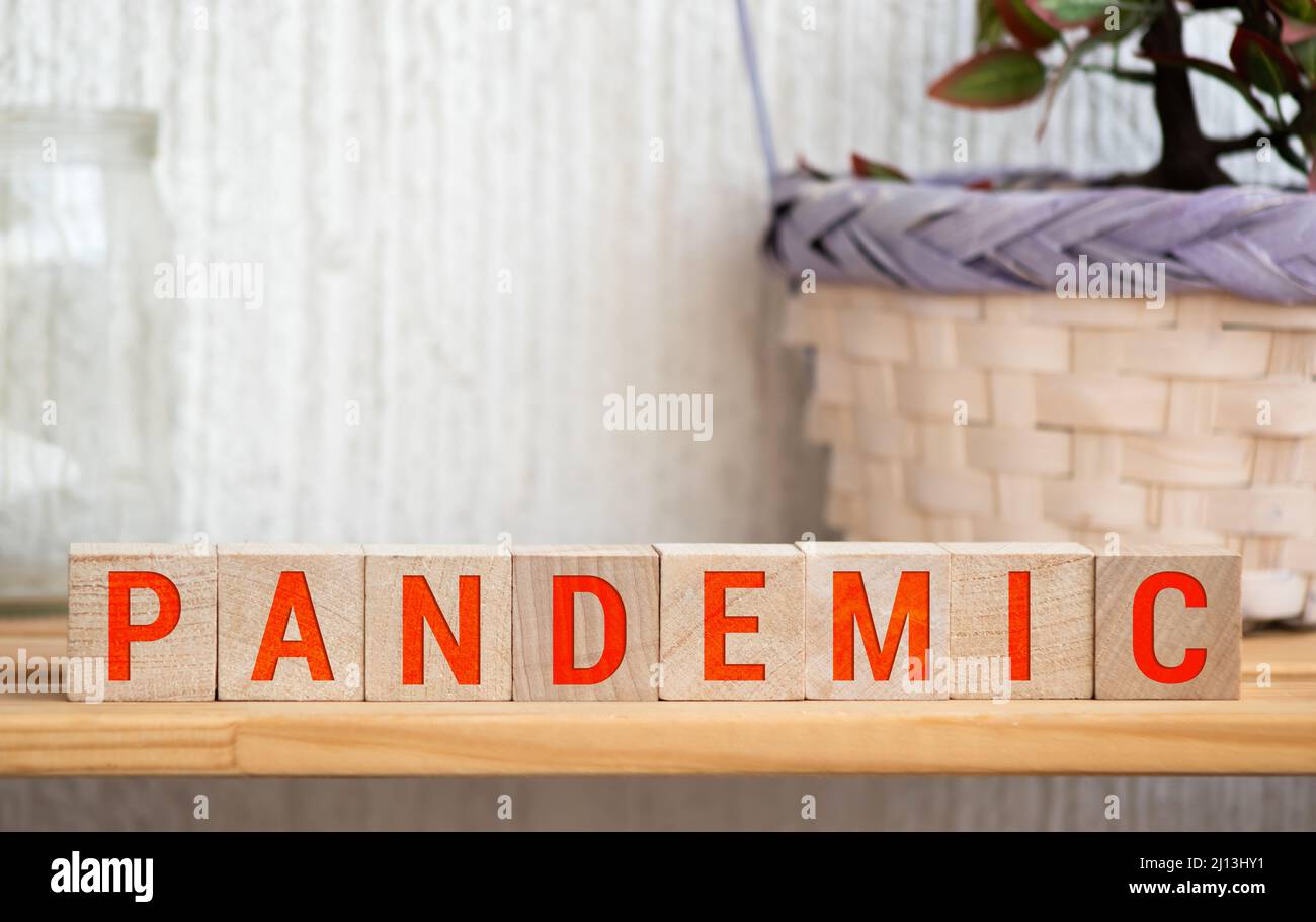 pandemic word written on wood block. pandemic text on wooden table for ...