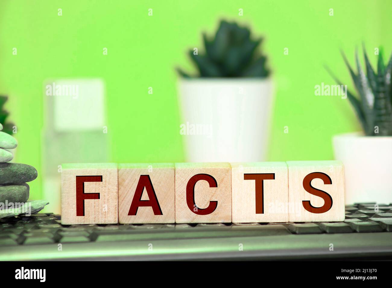 color cube figure with word FACTS on green book Stock Photo - Alamy